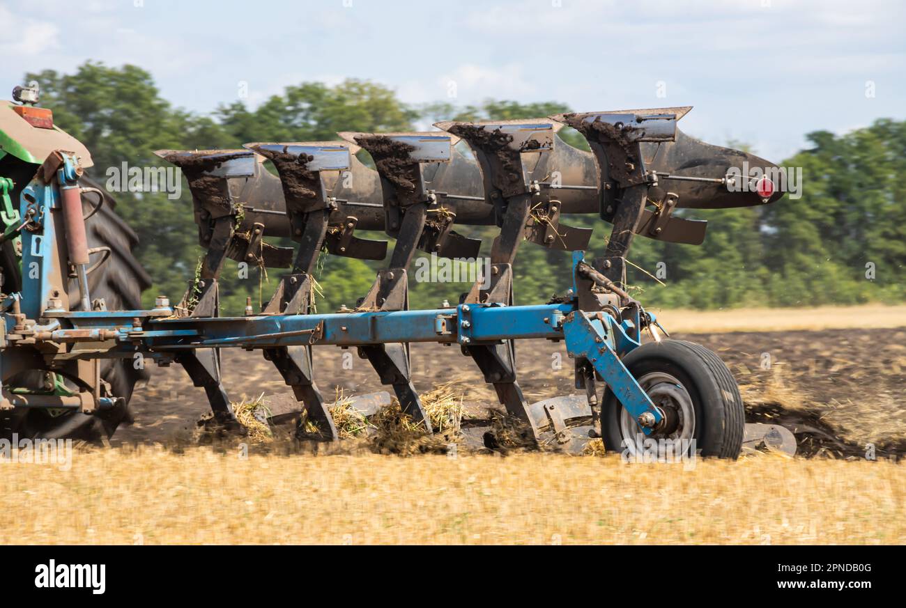 Agricultural tractor plowing a field before sowing Stock Photo - Alamy