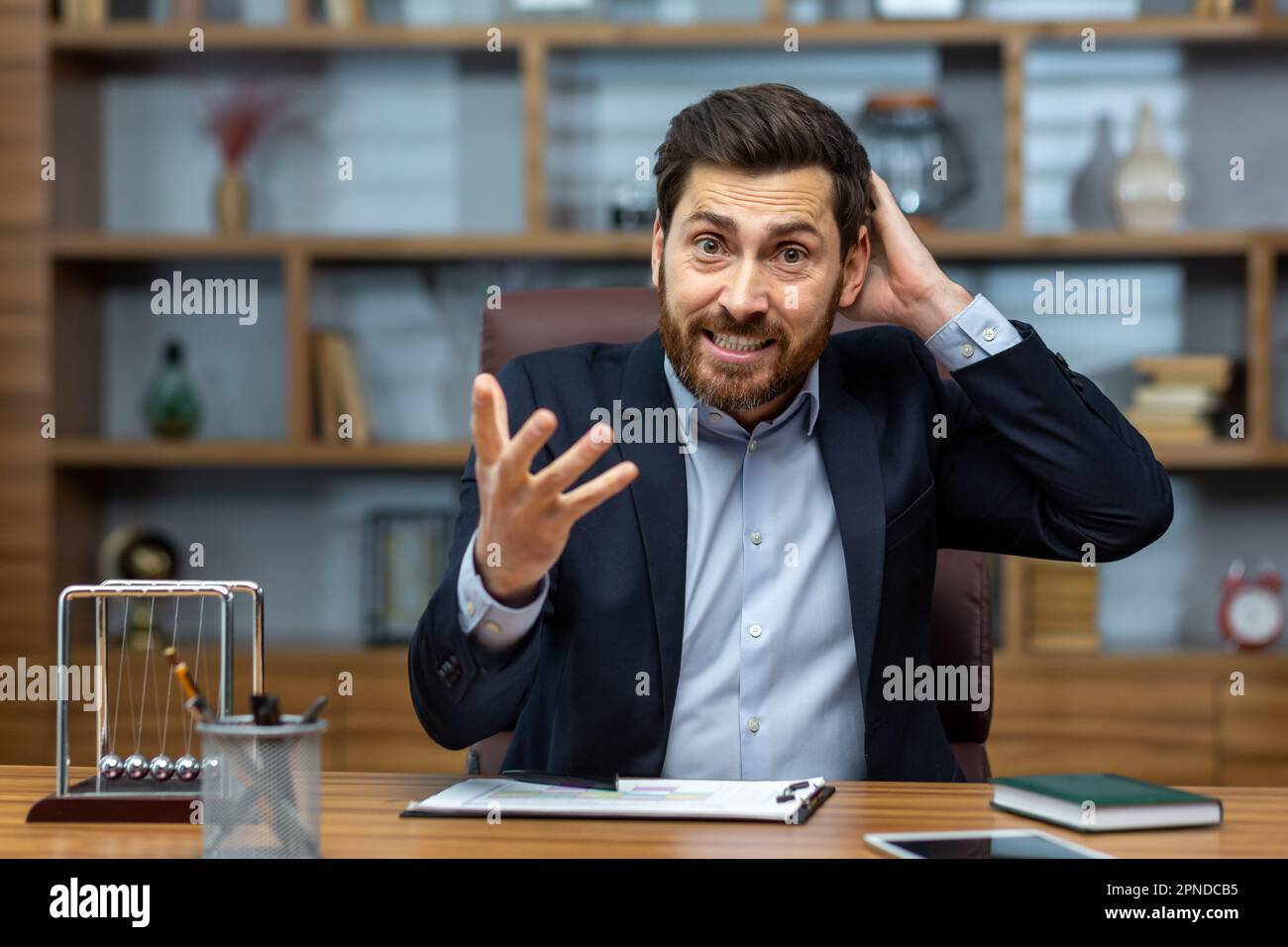 Angry boss yelling at camera, mature senior man working inside office ...