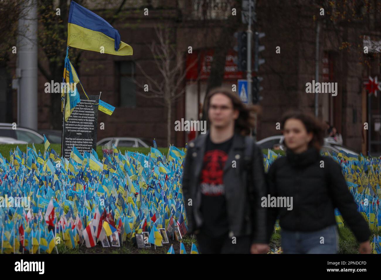 Kyiv, Ukraine. 14th Apr, 2023. People walk past blue and yellow ...