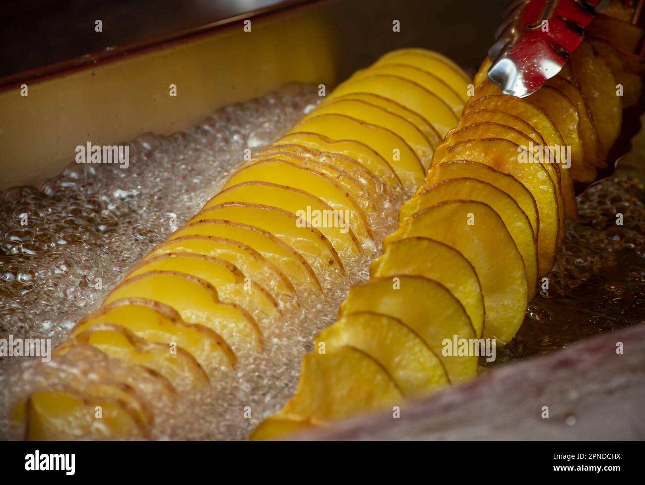 Spiral potatoes fried, on wooden sticks, spiral. Selling food at the ...