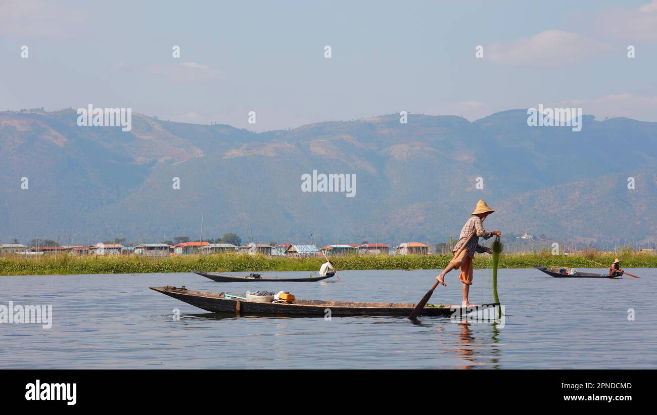 An Inle Lake one-legged fisherman on his wooden boat, Shan State ...