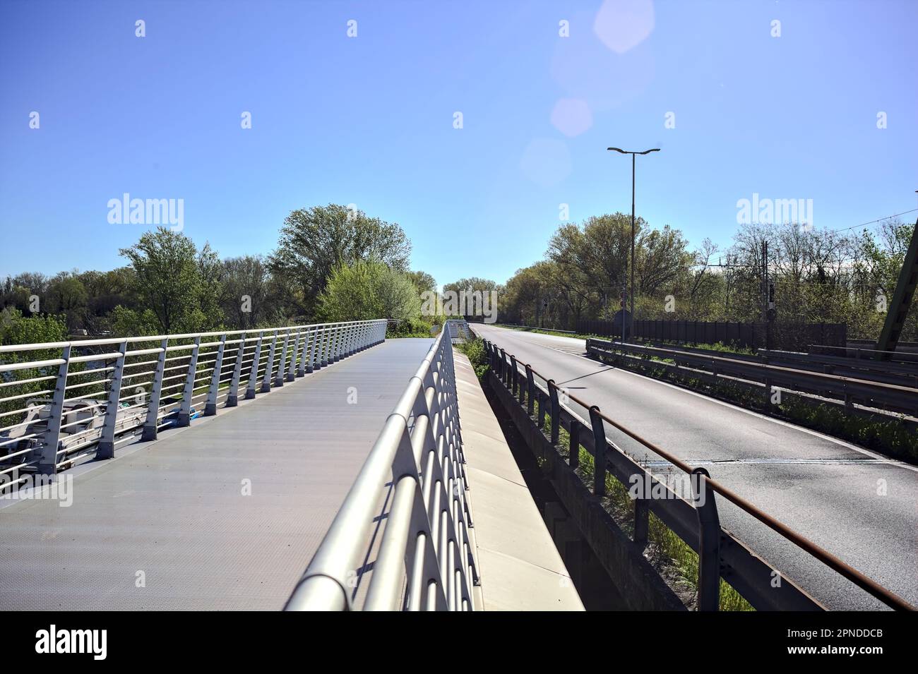 Bridge with a road and a railroad track over a river on a sunny day ...