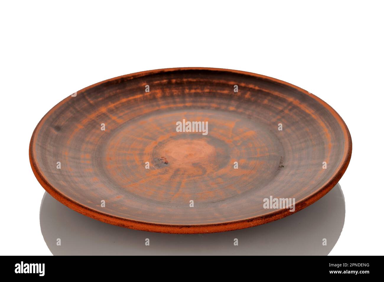 One clay plate, macro, isolated on white background Stock Photo - Alamy