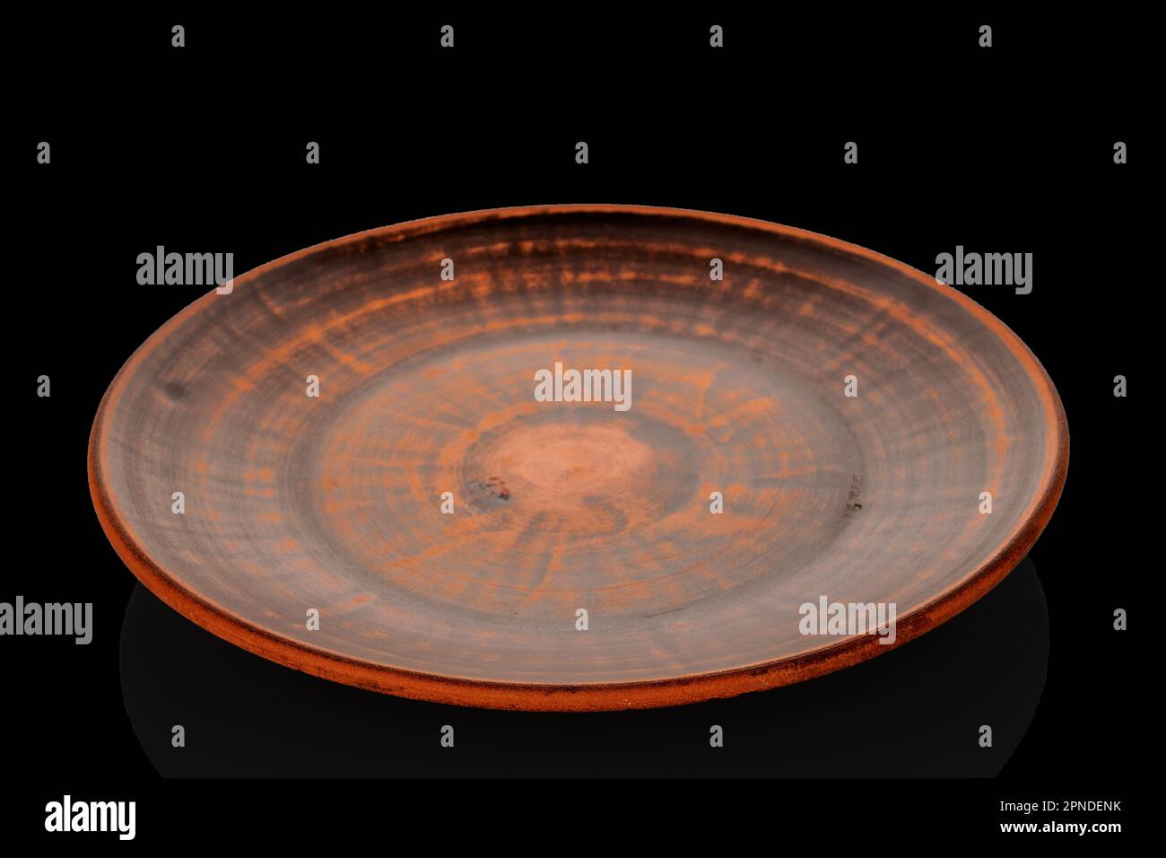 One clay plate, macro, isolated on black background Stock Photo - Alamy