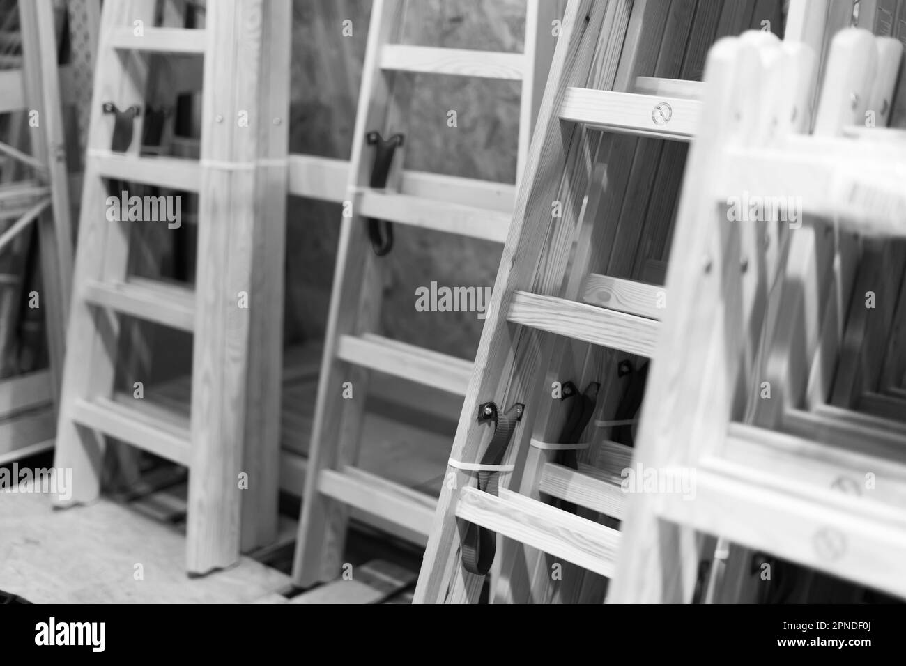 Many Wooden ladders. Stack of wooden stairs in a store Stock Photo - Alamy