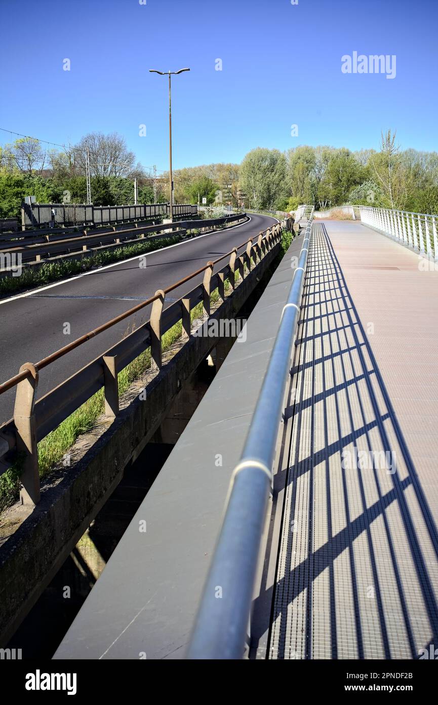 Bridge with a road and a railroad track over a river on a sunny day ...