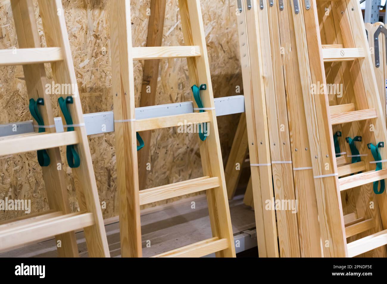Many Wooden ladders. Stack of wooden stairs in a store Stock Photo - Alamy