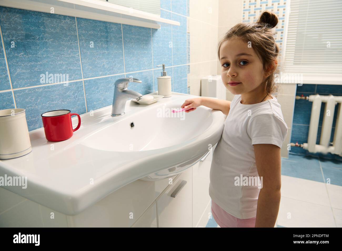 Holding standing childhood hygiene sink hi-res stock photography and ...