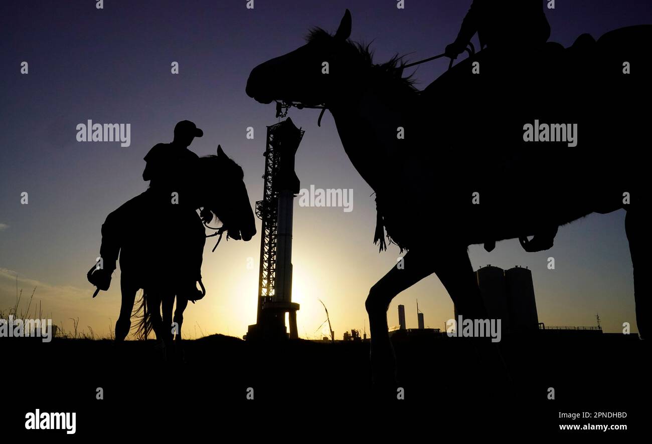 Horseback riders pass SpaceX's Starship, the world's biggest and most ...