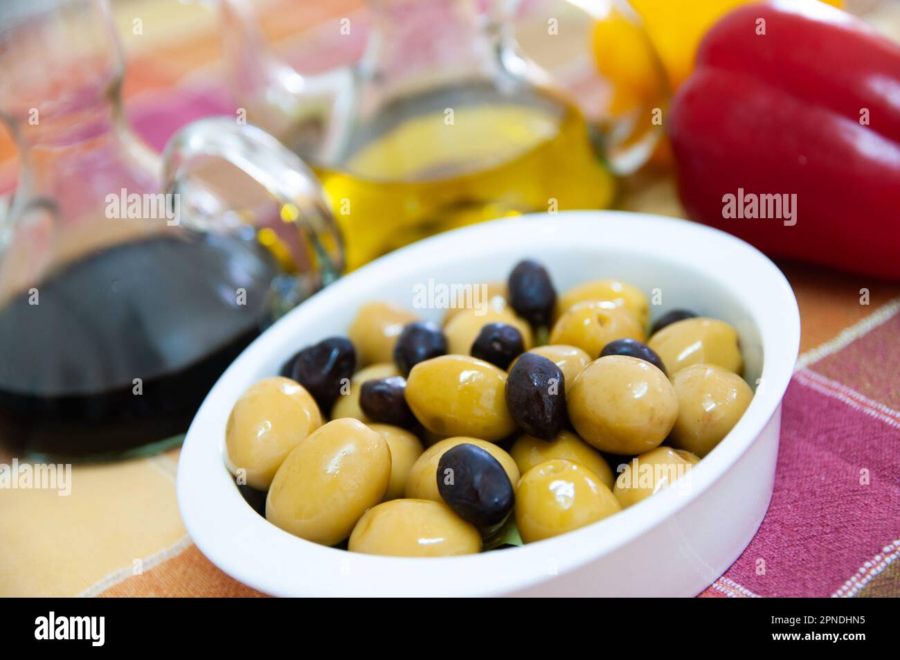 Green and black olives with olive oil and balsamic vinegar Stock Photo ...
