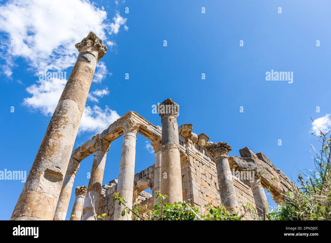 Low-angle view of Roman columns against a blue sky in the ancient city ...