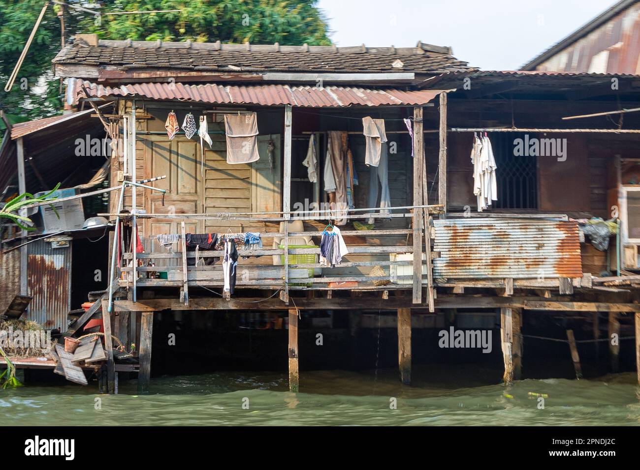 Houses at a klong in downtown Bangkok. Klongs are the canals, that ...