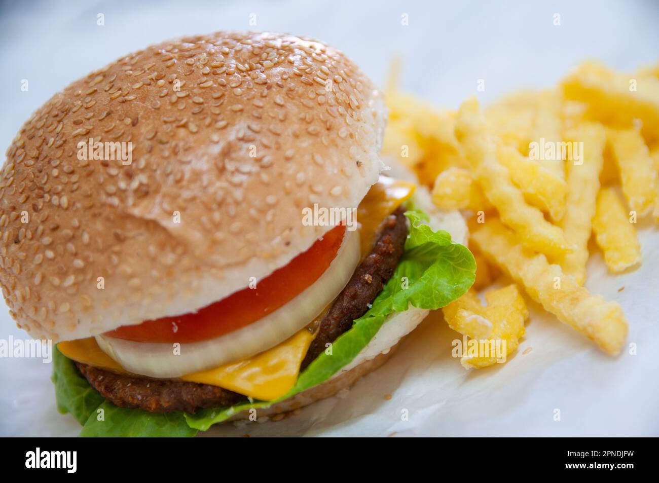 Double Burger served with potato chips Stock Photo - Alamy