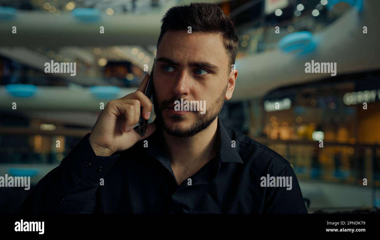 Caucasian hispanic male consultant businessman young man employee speak mobile phone in business ...