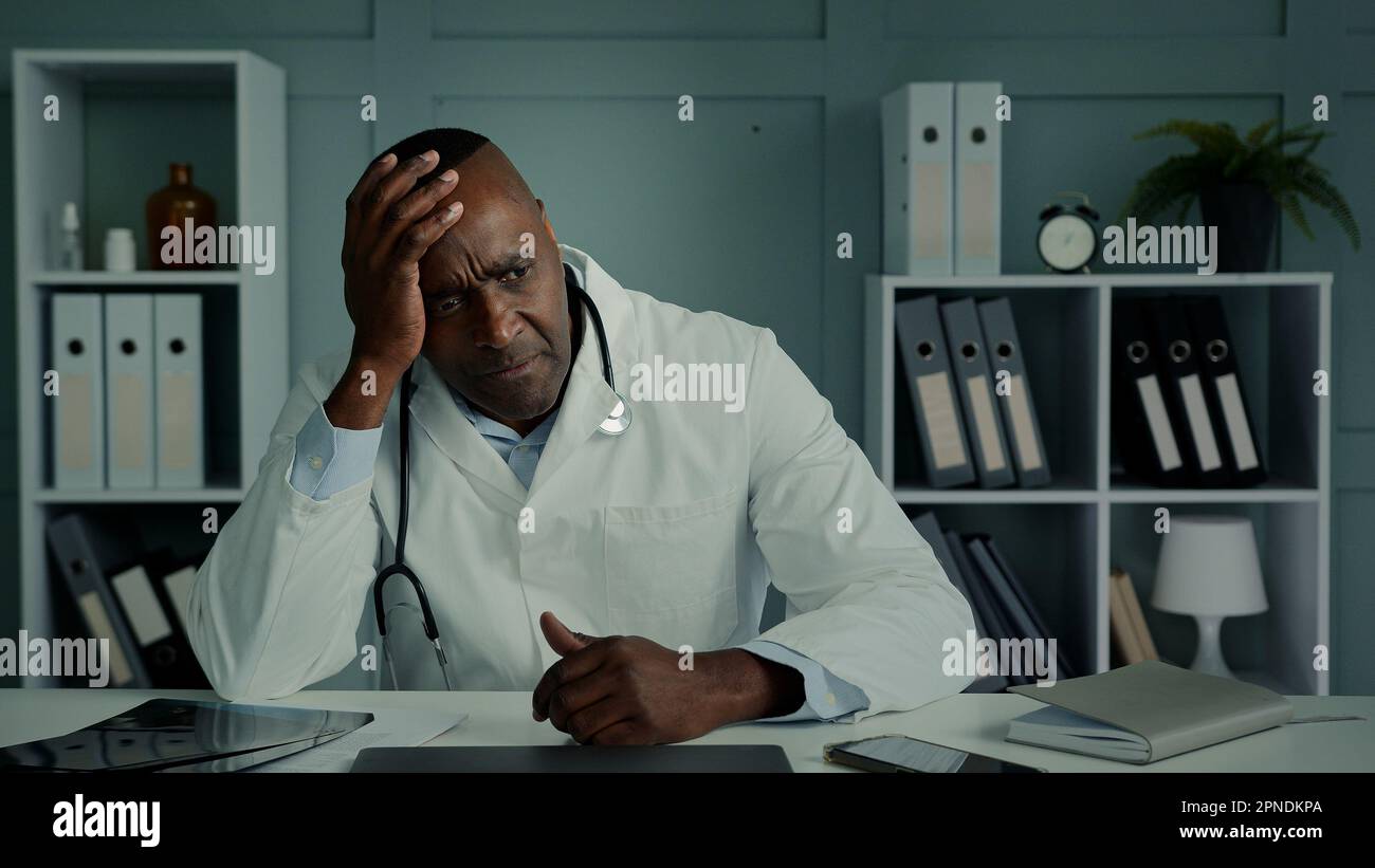 Pensive thoughtful sad african doctor ethnic elderly age man feel ...