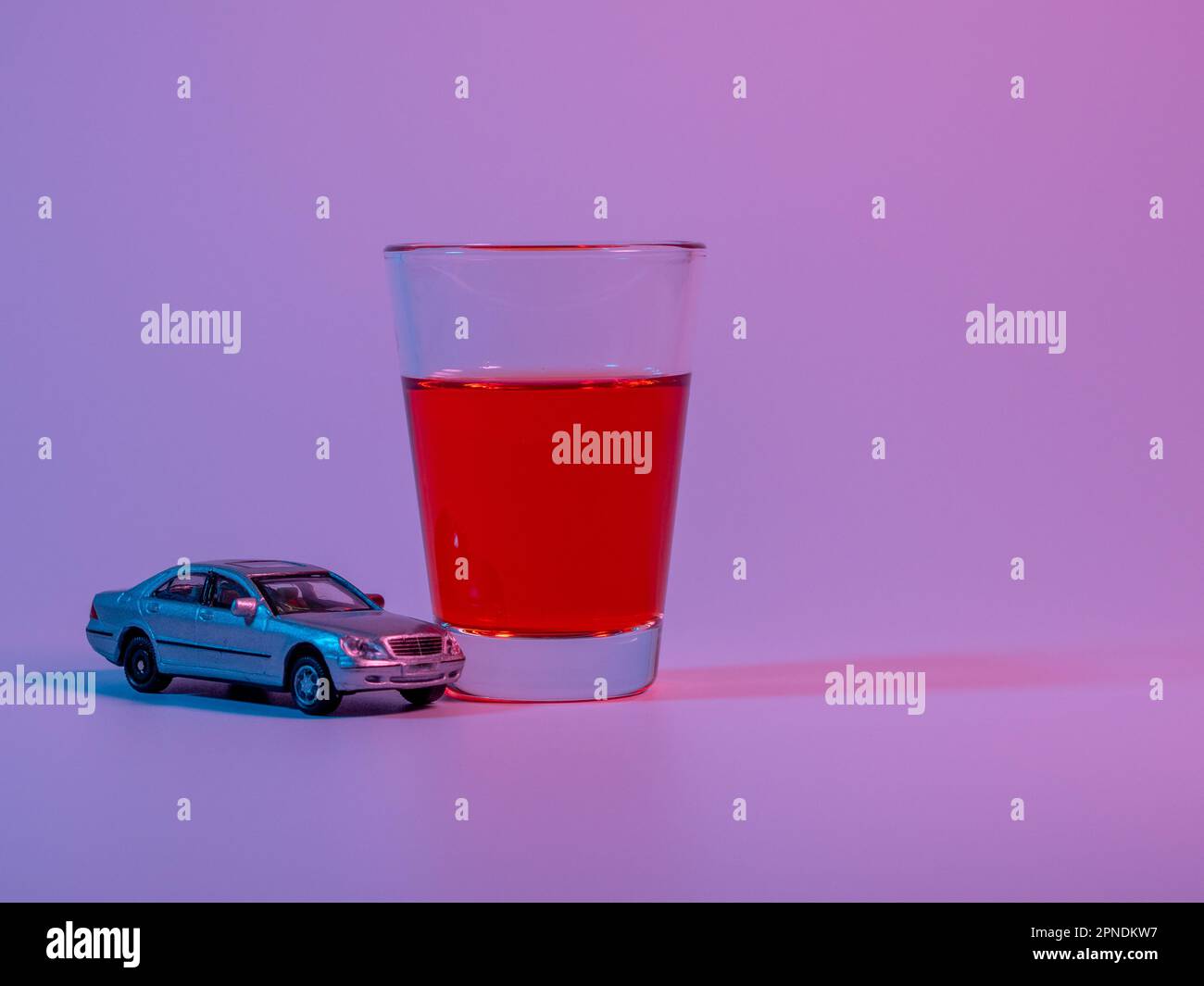 Mini car accident. Alcohol and a toy car on a light background. Drunk ...