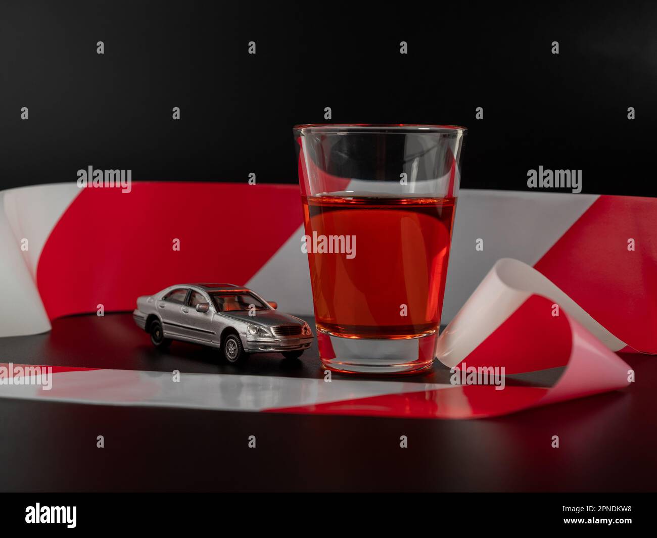 Mini car accident. Alcohol and a toy car on a black background. Drunk ...