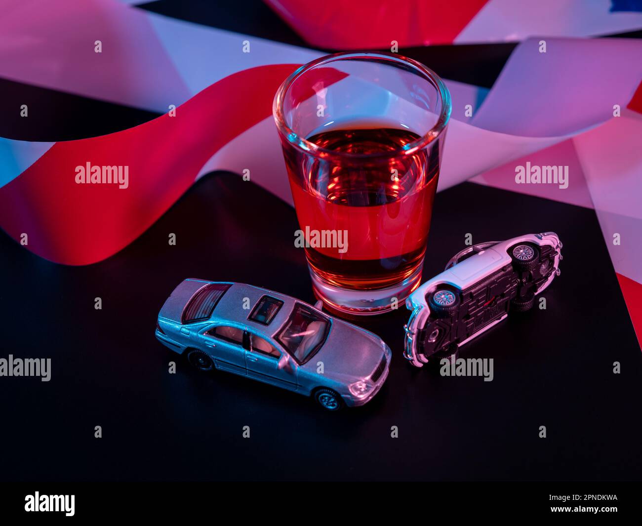 Mini car accident. Alcohol and a toy car on a black background. Drunk ...