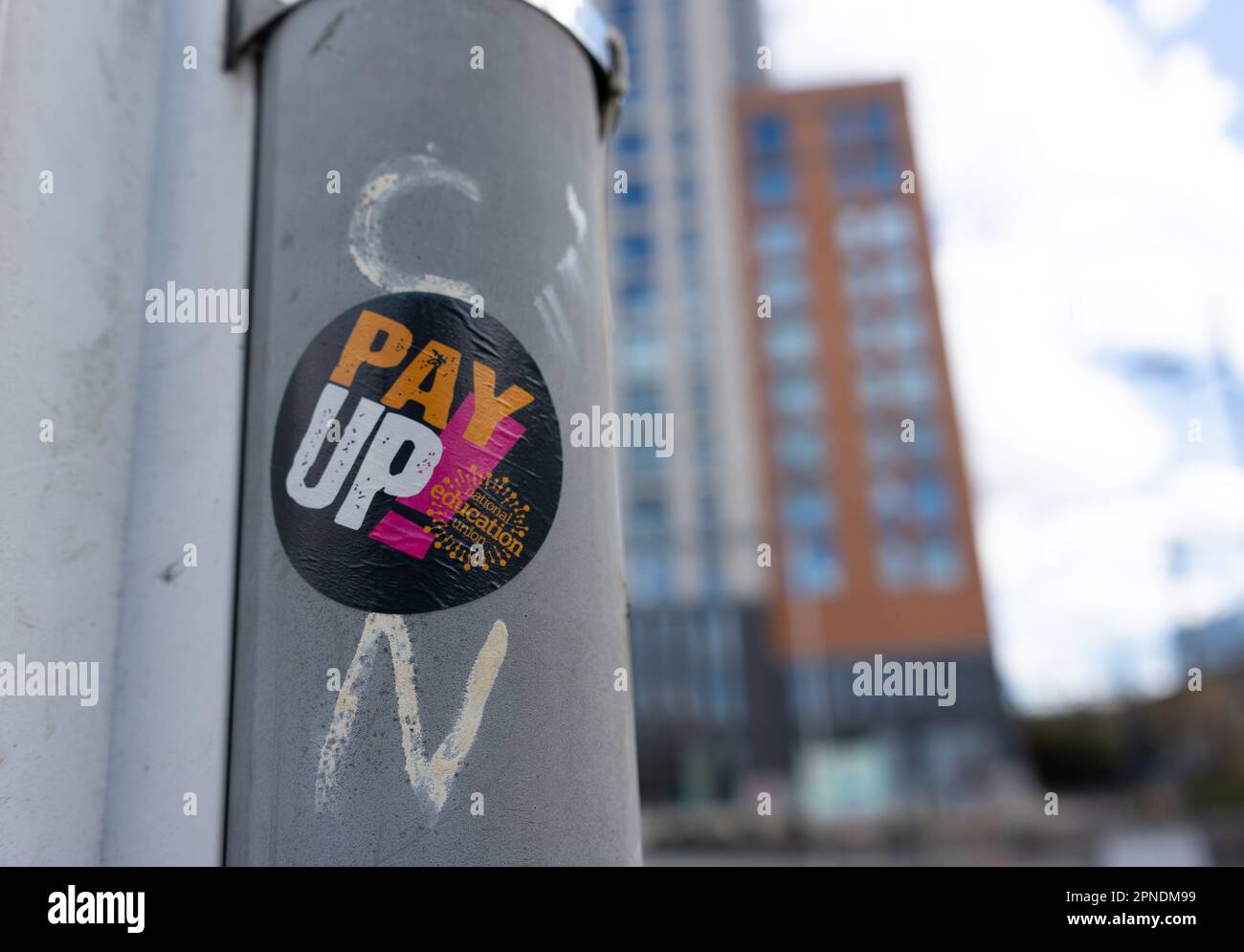 A National Education Union sticker featuring the slogan "pay up!" on a ...