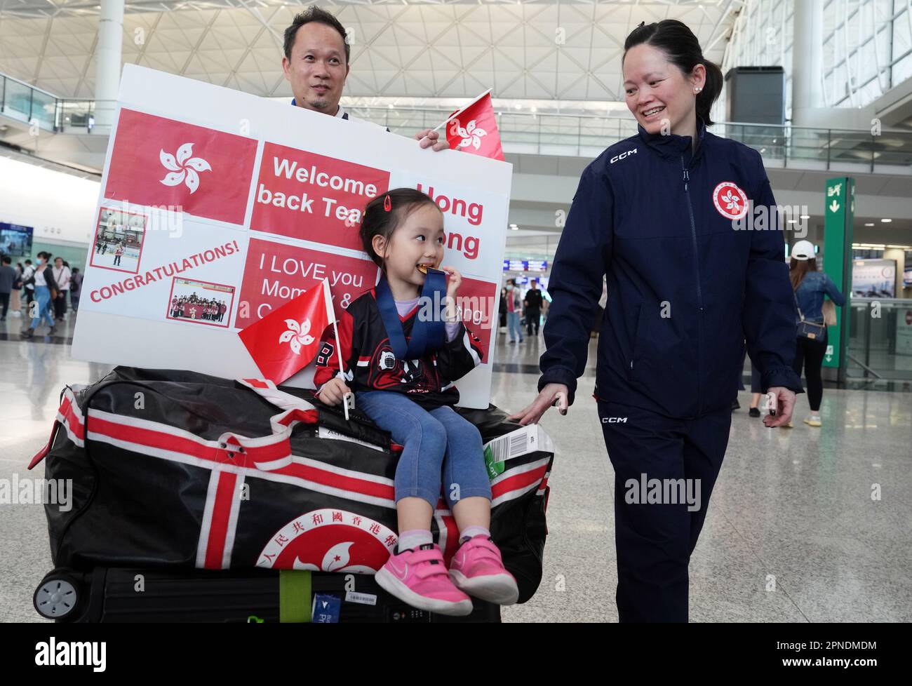 Team captain Adrienne May Li (right) is welcomed home by with her ...