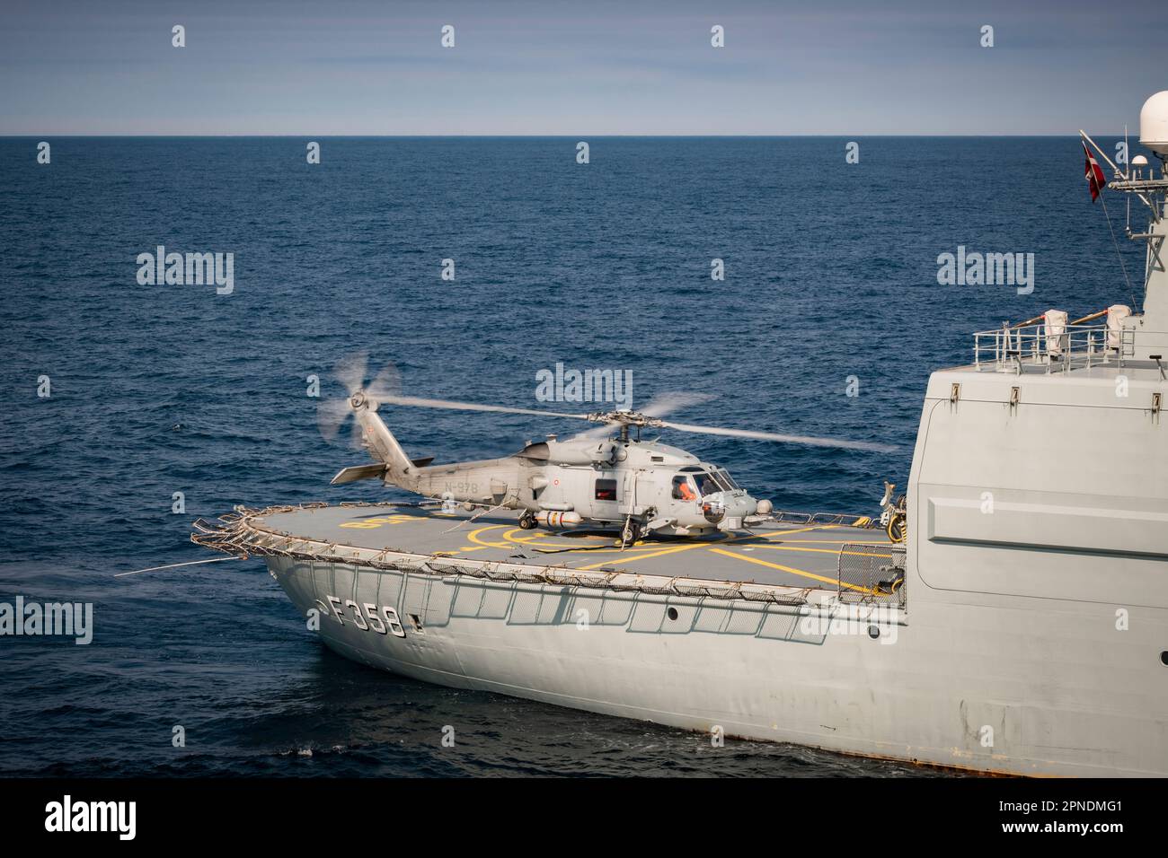 Royal Danish Navy MH-60R Seahawk helicopter flying from patrol ship ...