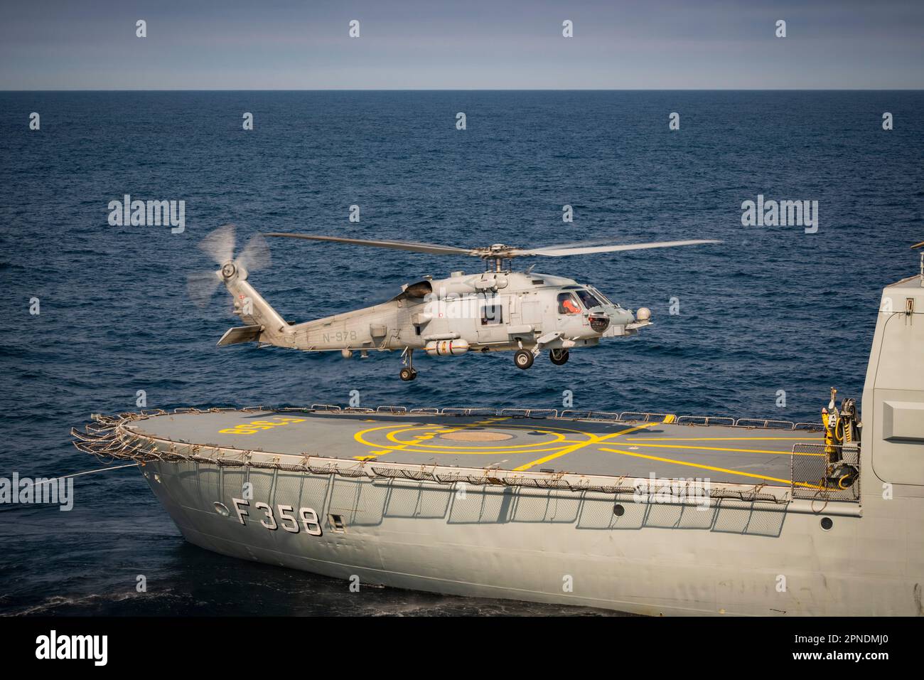 Royal Danish Navy MH-60R Seahawk helicopter flying from patrol ship ...