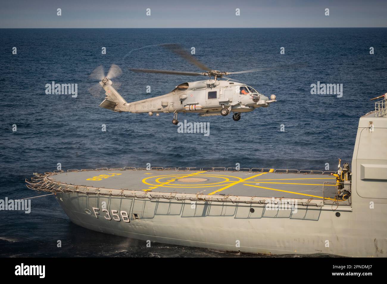 Royal Danish Navy MH-60R Seahawk helicopter flying from patrol ship ...