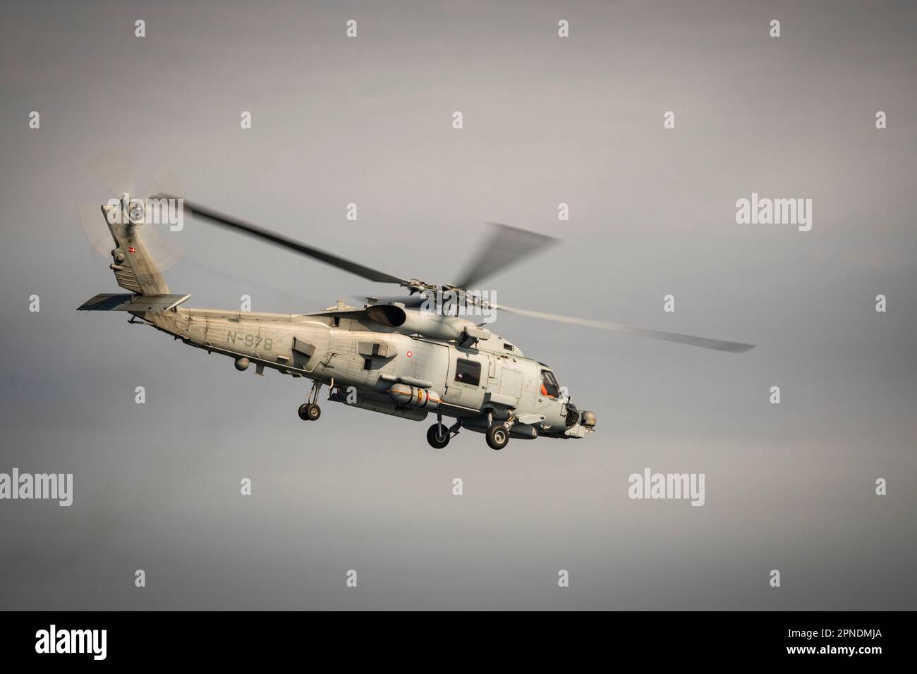 Royal Danish Navy MH-60R Seahawk helicopter flying from patrol ship ...