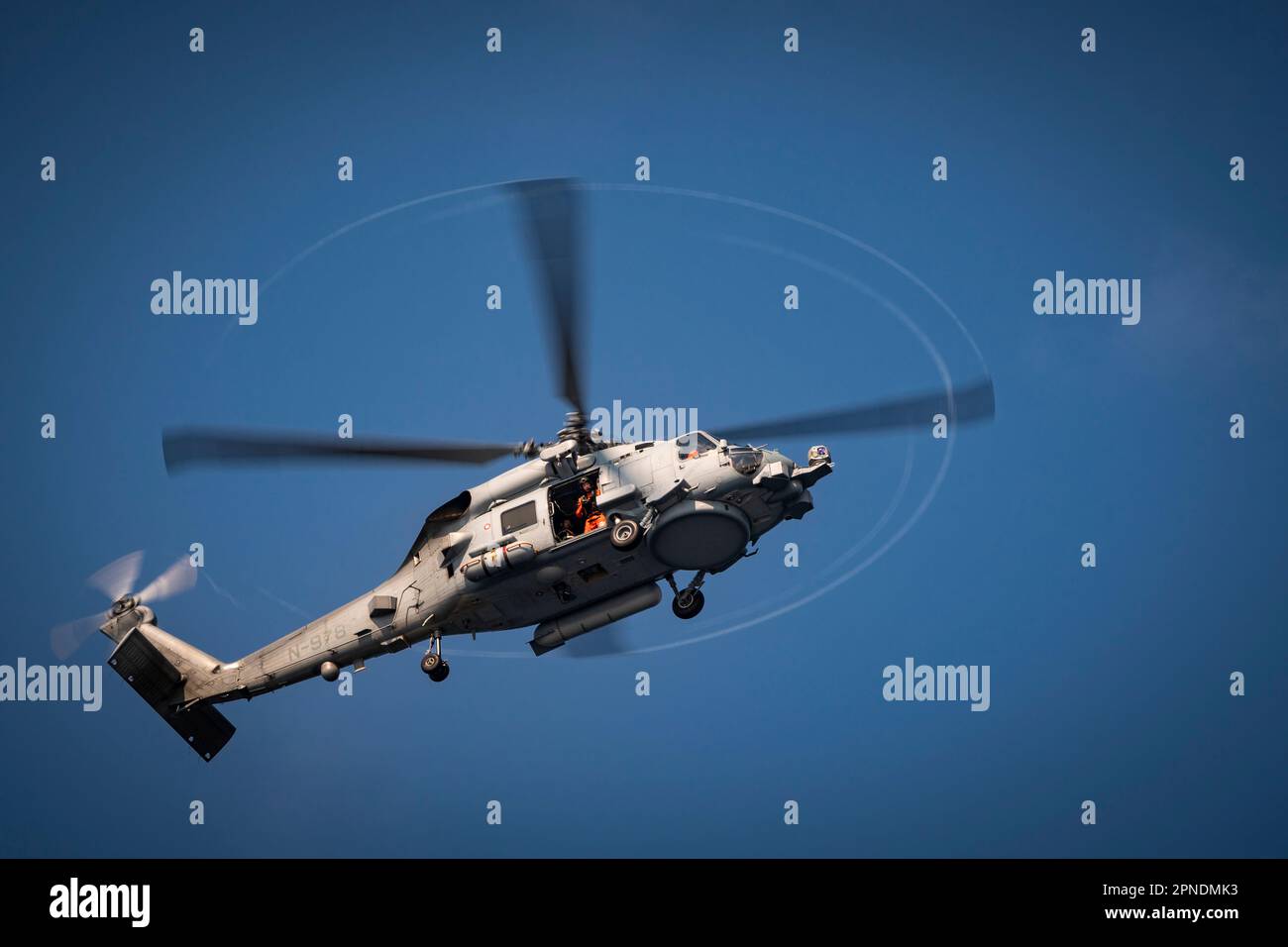 Royal Danish Navy MH-60R Seahawk helicopter flying from patrol ship ...