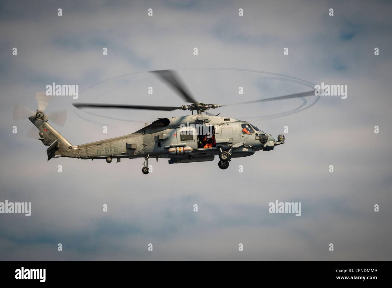 Royal Danish Navy MH-60R Seahawk helicopter flying from patrol ship ...