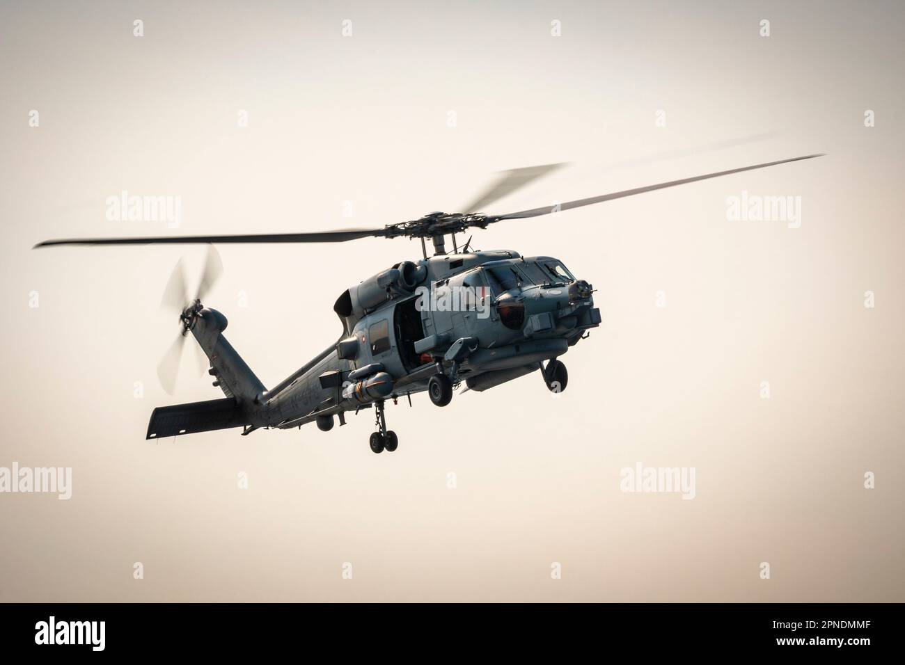 Royal Danish Navy MH-60R Seahawk helicopter flying from patrol ship ...