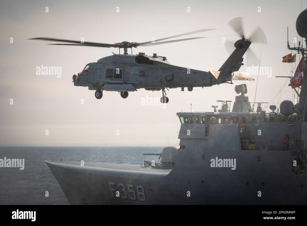 Royal Danish Navy MH-60R Seahawk helicopter flying from patrol ship ...