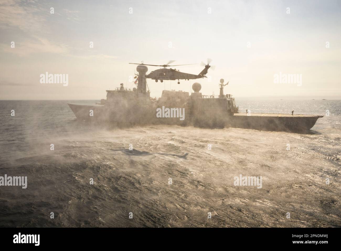 Royal Danish Navy MH-60R Seahawk helicopter flying from patrol ship ...