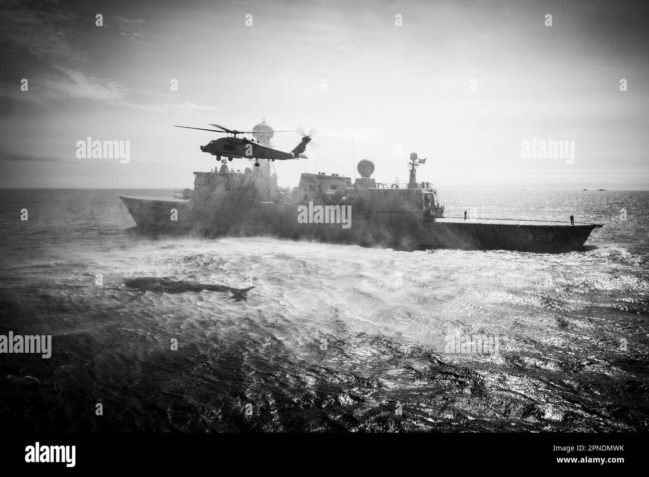 Royal Danish Navy MH-60R Seahawk helicopter flying from patrol ship ...