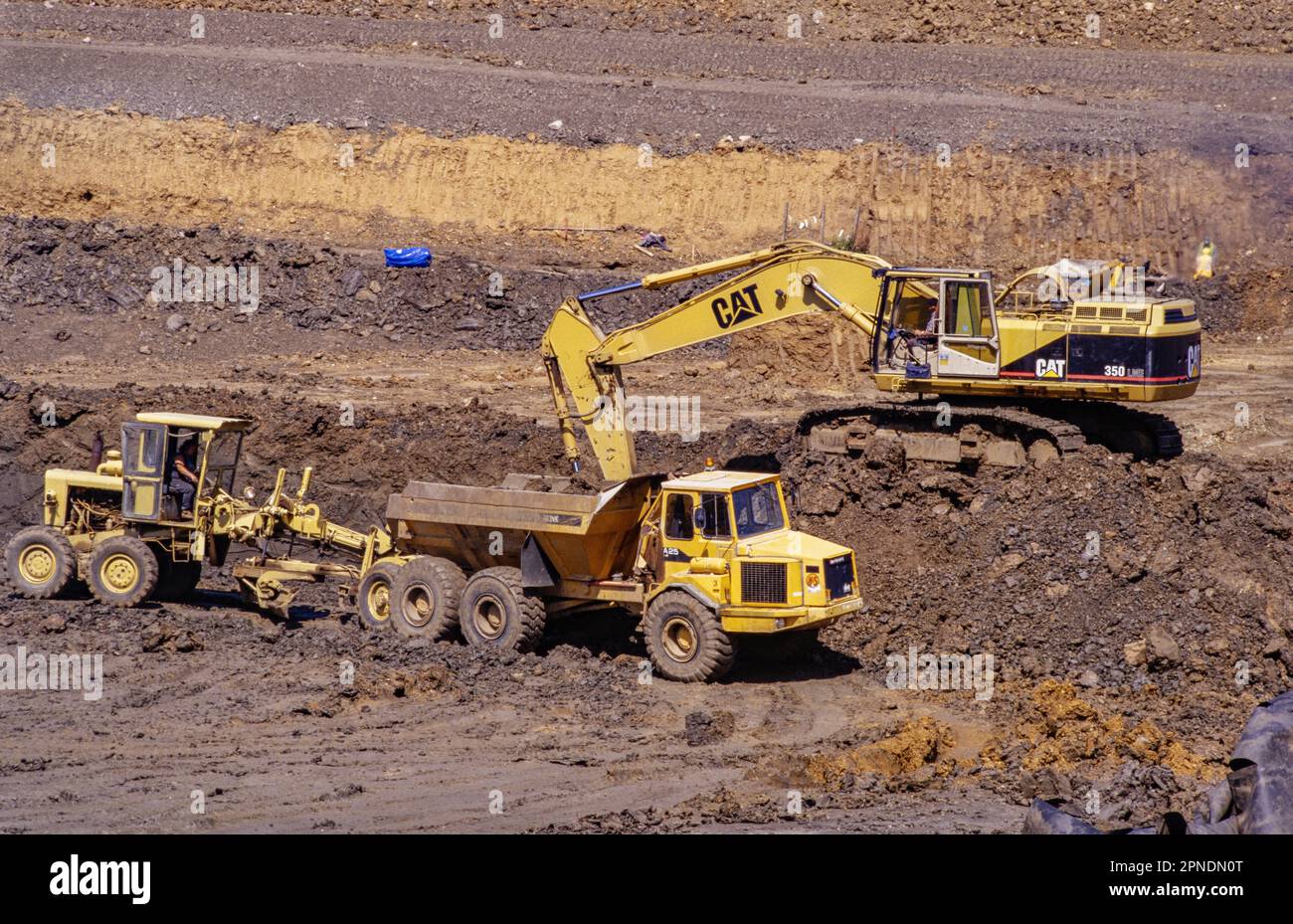 Digger, Dump truck and Grader working on a land reclamation site in ...