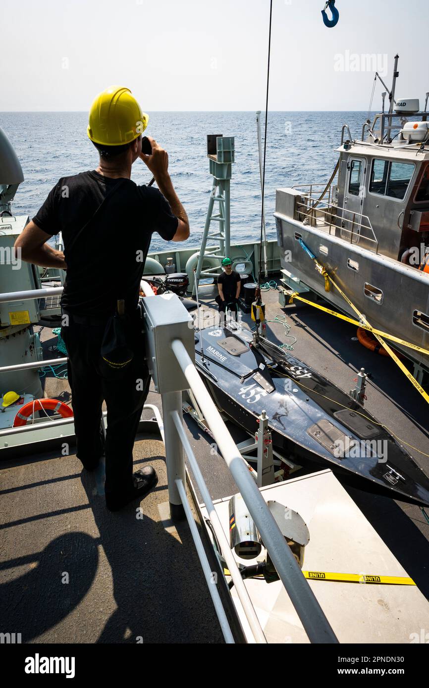 Royal Canadian Navy sailors crane a Meggitt Hammerhead drone into the ...