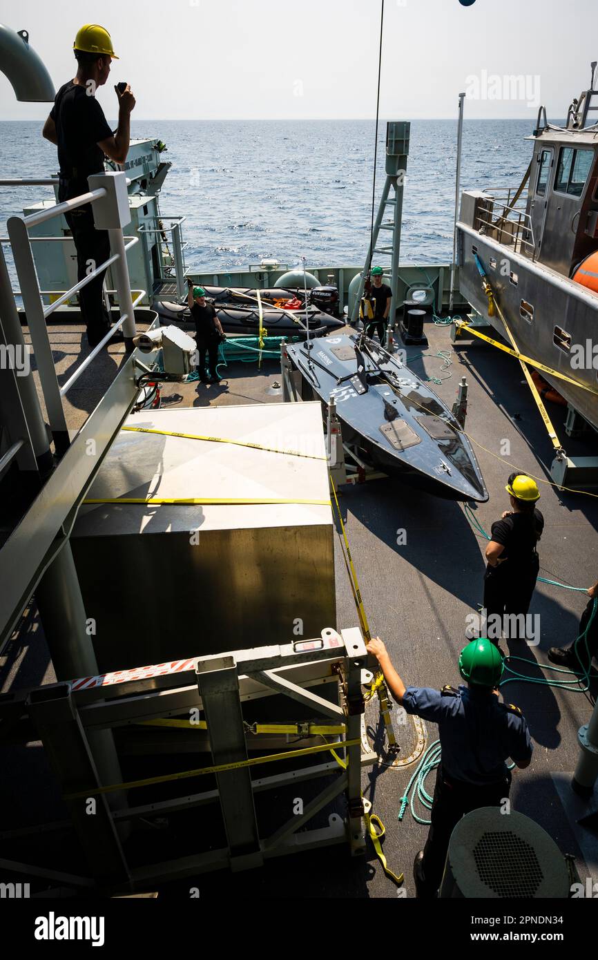 Royal Canadian Navy sailors crane a Meggitt Hammerhead drone into the ...