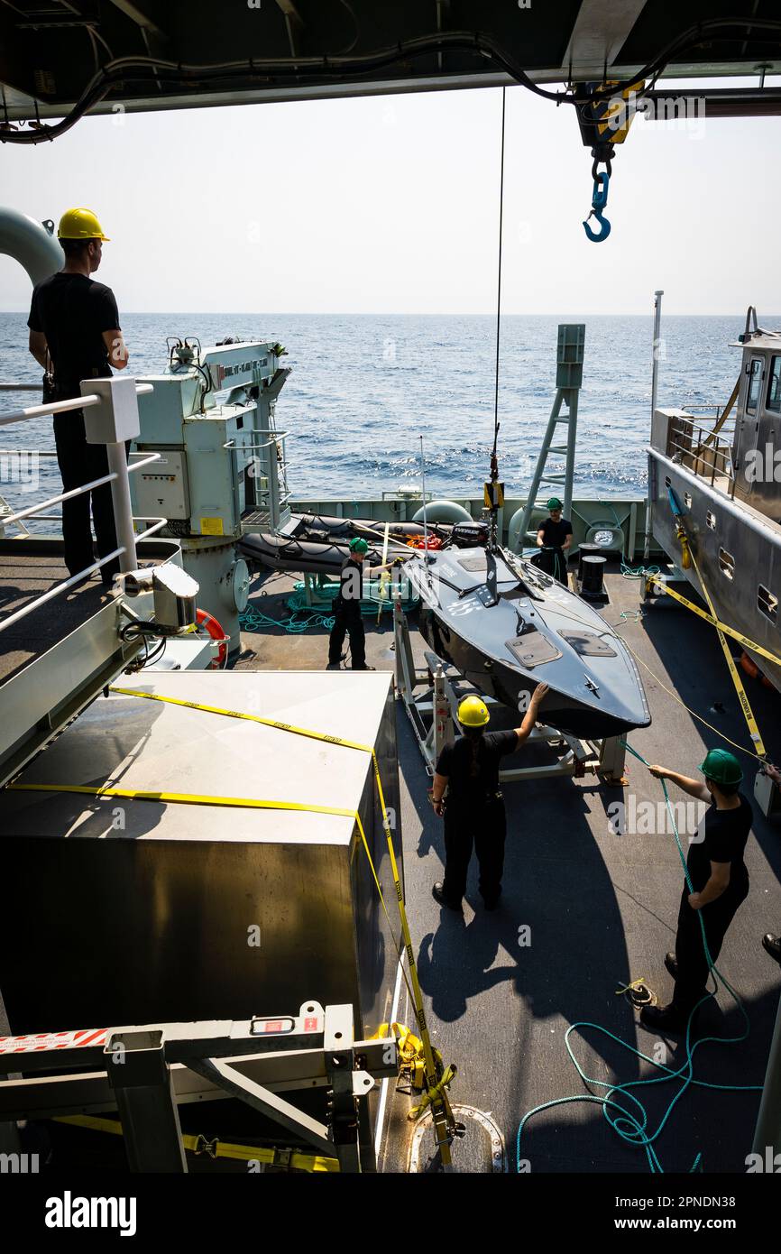 Royal Canadian Navy sailors crane a Meggitt Hammerhead drone into the ...