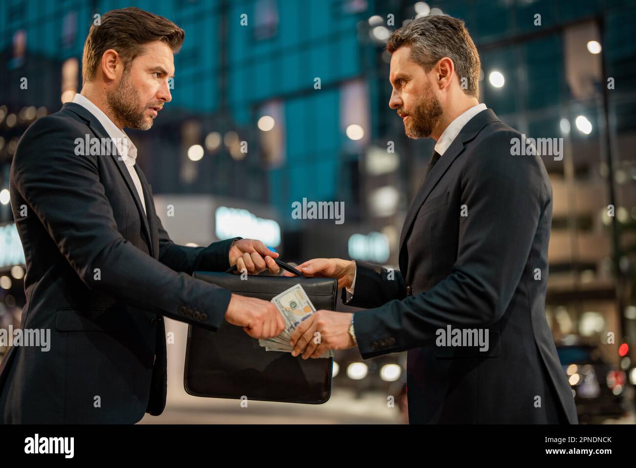 Businessman giving money to his partner while making contract ...