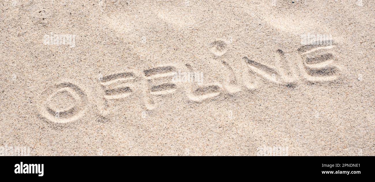 Sand background. Word Offline written on sand Stock Photo - Alamy