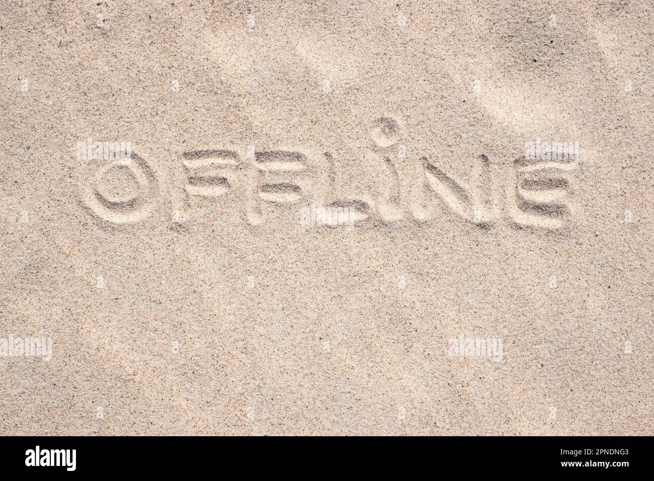 Sand background. Word Offline written on sand Stock Photo - Alamy
