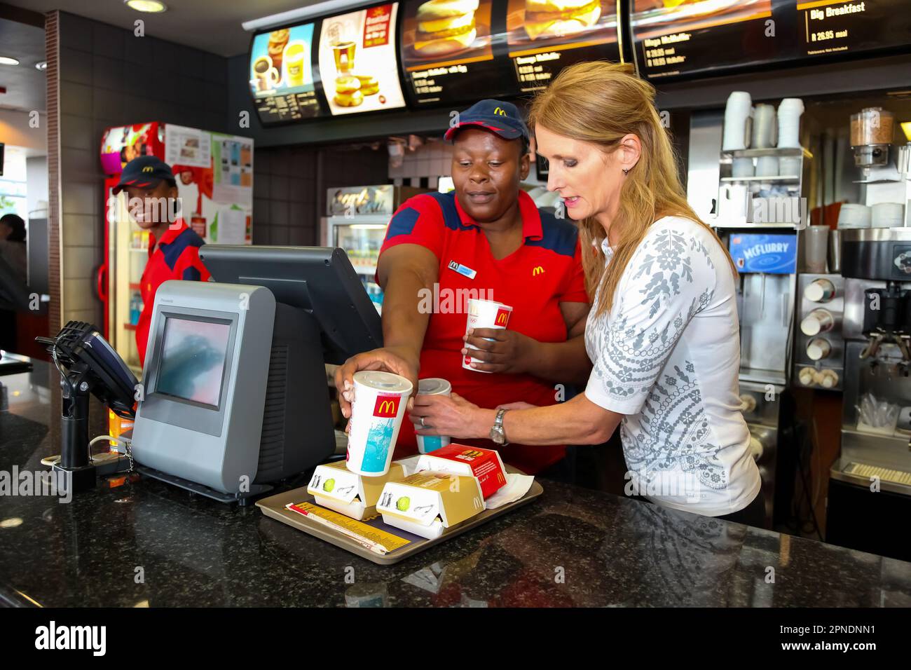A pair of African American female workers and their manager working at ...