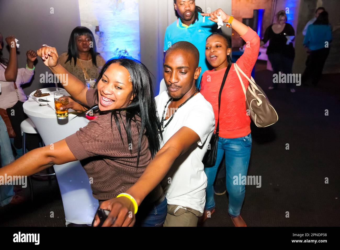 A young African American couple enjoying a night out at a nightclub ...