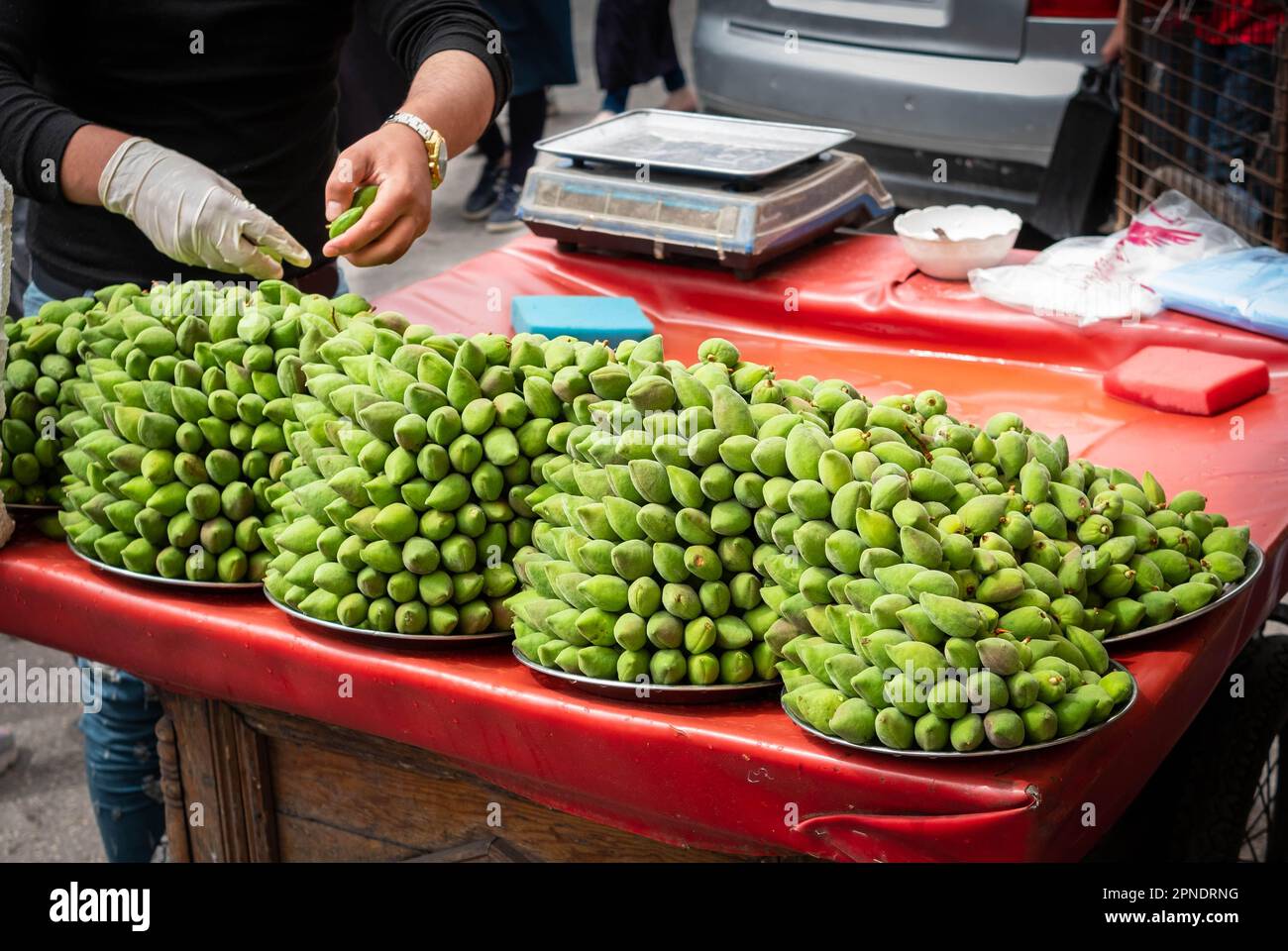 Pile of fresh almonds for sale on street, green almond Stock Photo - Alamy