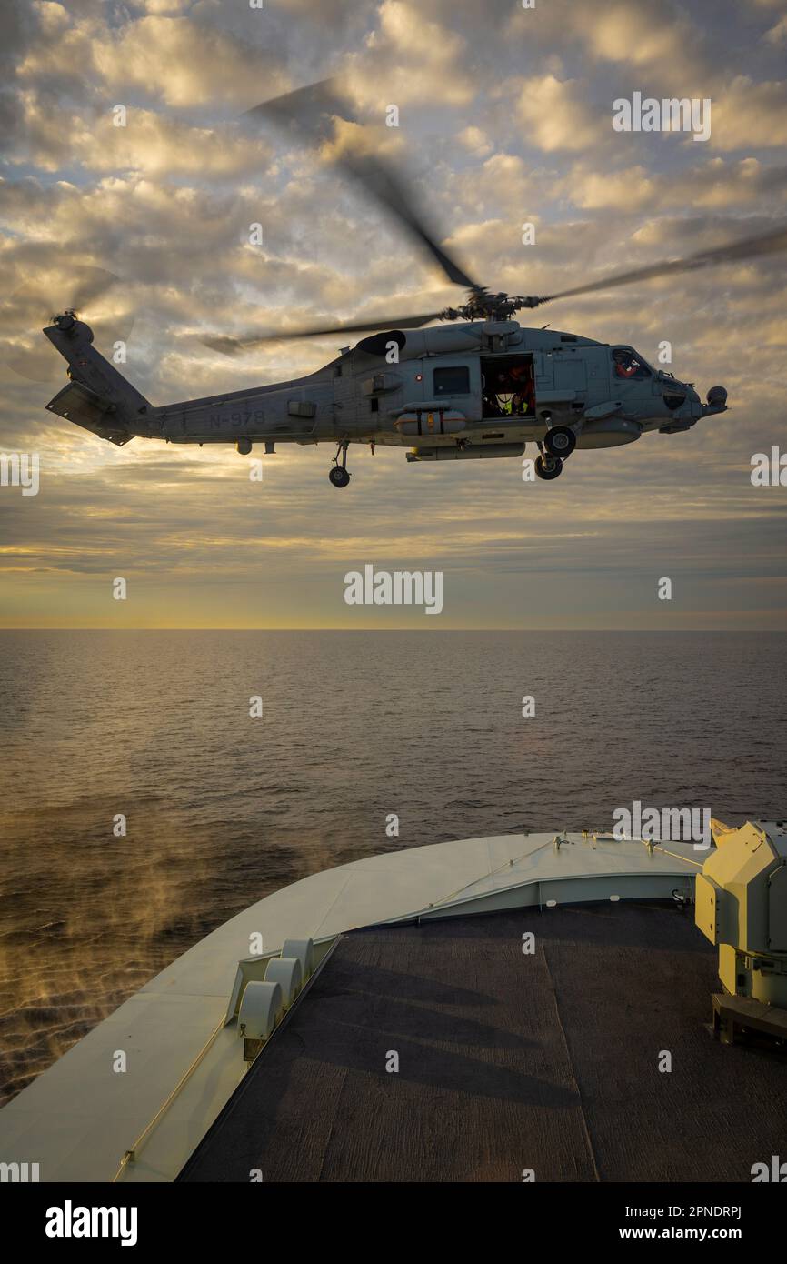 Royal Danish Navy MH-60R Seahawk helicopter flying from patrol ship ...