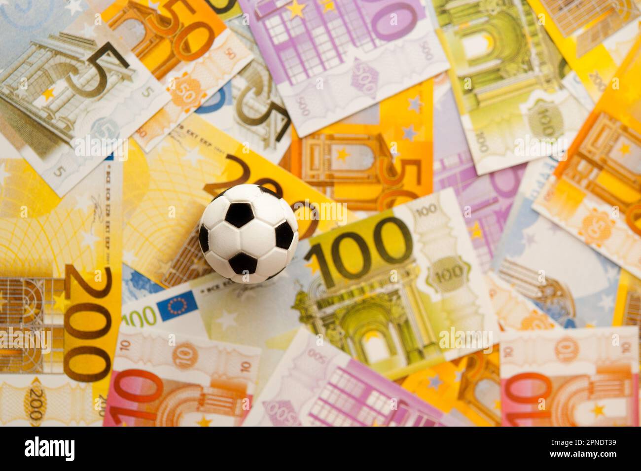 soccer ball over a background of money, sport and business concept ...