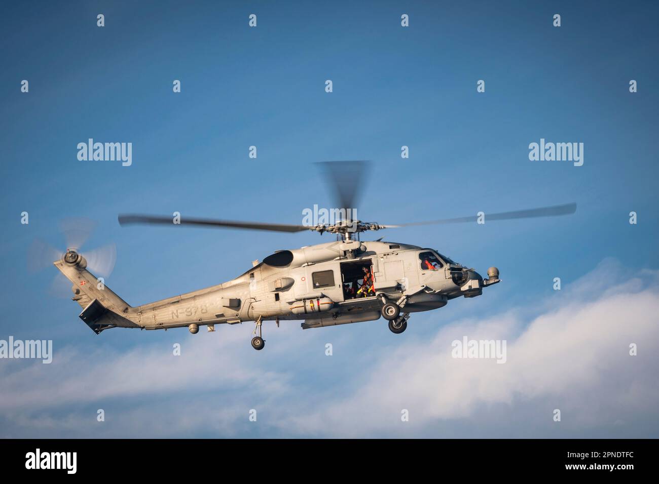 Royal Danish Navy MH-60R Seahawk helicopter flying from patrol ship ...