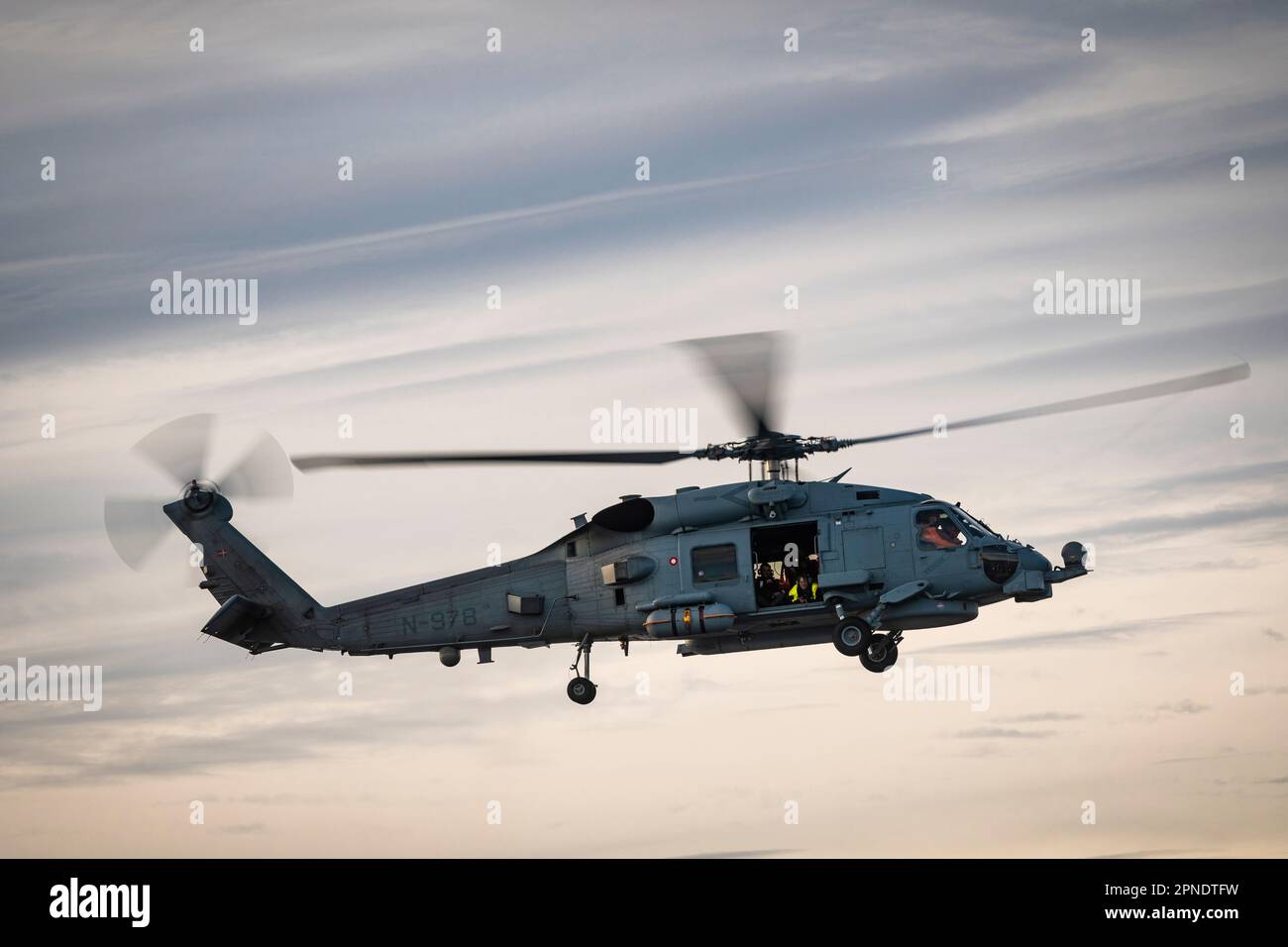 Royal Danish Navy MH-60R Seahawk helicopter flying from patrol ship ...