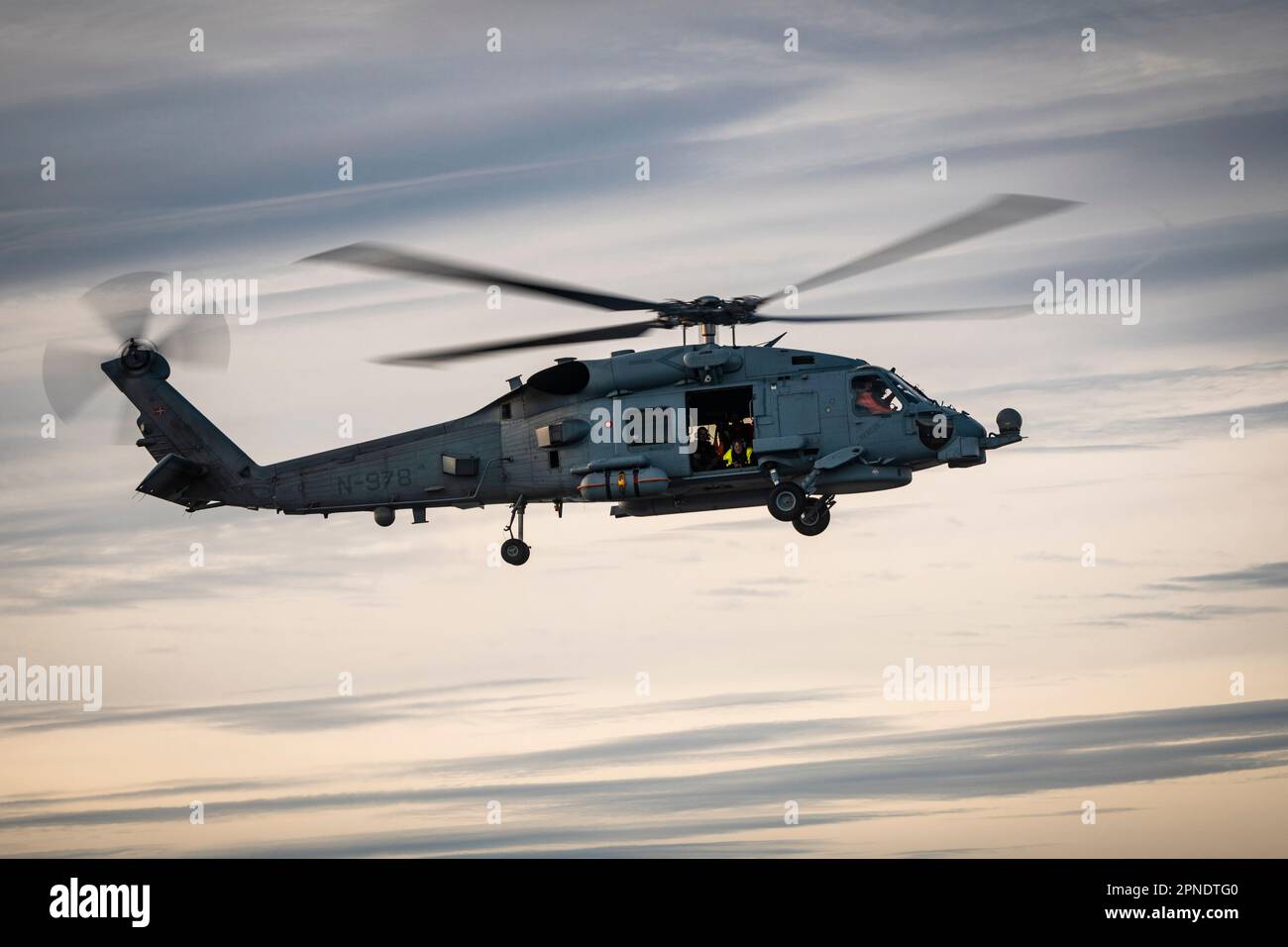 Royal Danish Navy MH-60R Seahawk helicopter flying from patrol ship ...