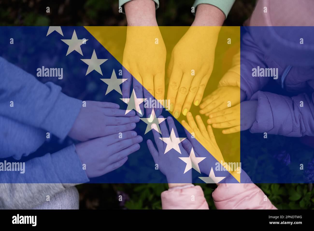 Hands of kids on background of Bosnia and Herzegovina flag. Bosnian ...